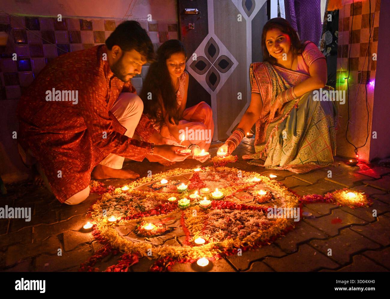 NEW DELHI, INDIA - OCTOBER 20: People light diyas, earthen lamps ...