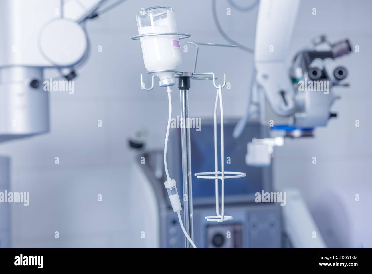 IV infusion bottle on stand in a clean ophthalmic operating room with ...
