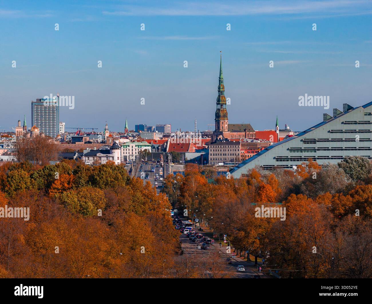 Riga Old Town in golden autumn with St. Peter's spire and library Stock ...