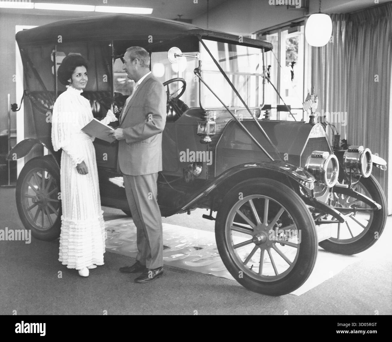 Car salesman with female customer Black and White Stock Photos & Images ...
