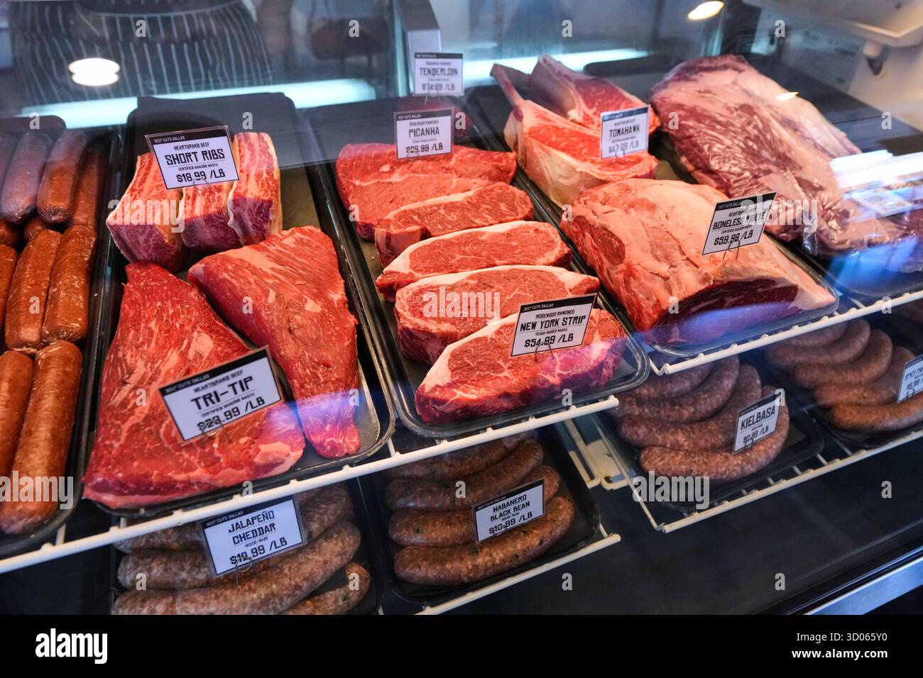 A selection of beef cuts and sausages are displayed at Deept Cuts ...