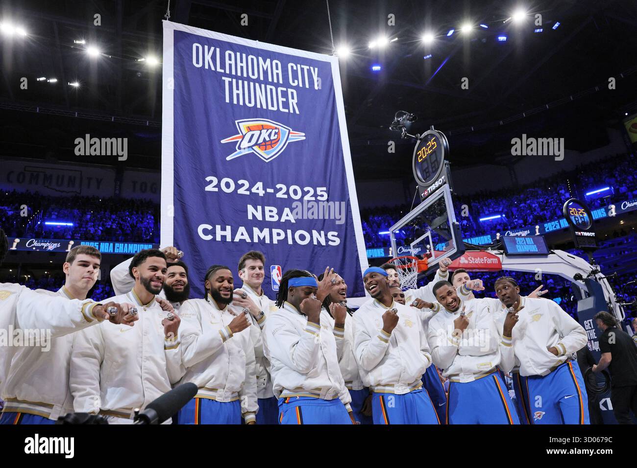 The Oklahoma City Thunder pose with their championship rings in front ...