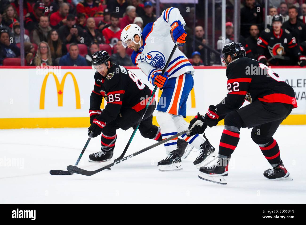 Edmonton Oilers' Evan Bouchard (2) moves the puck between Ottawa ...