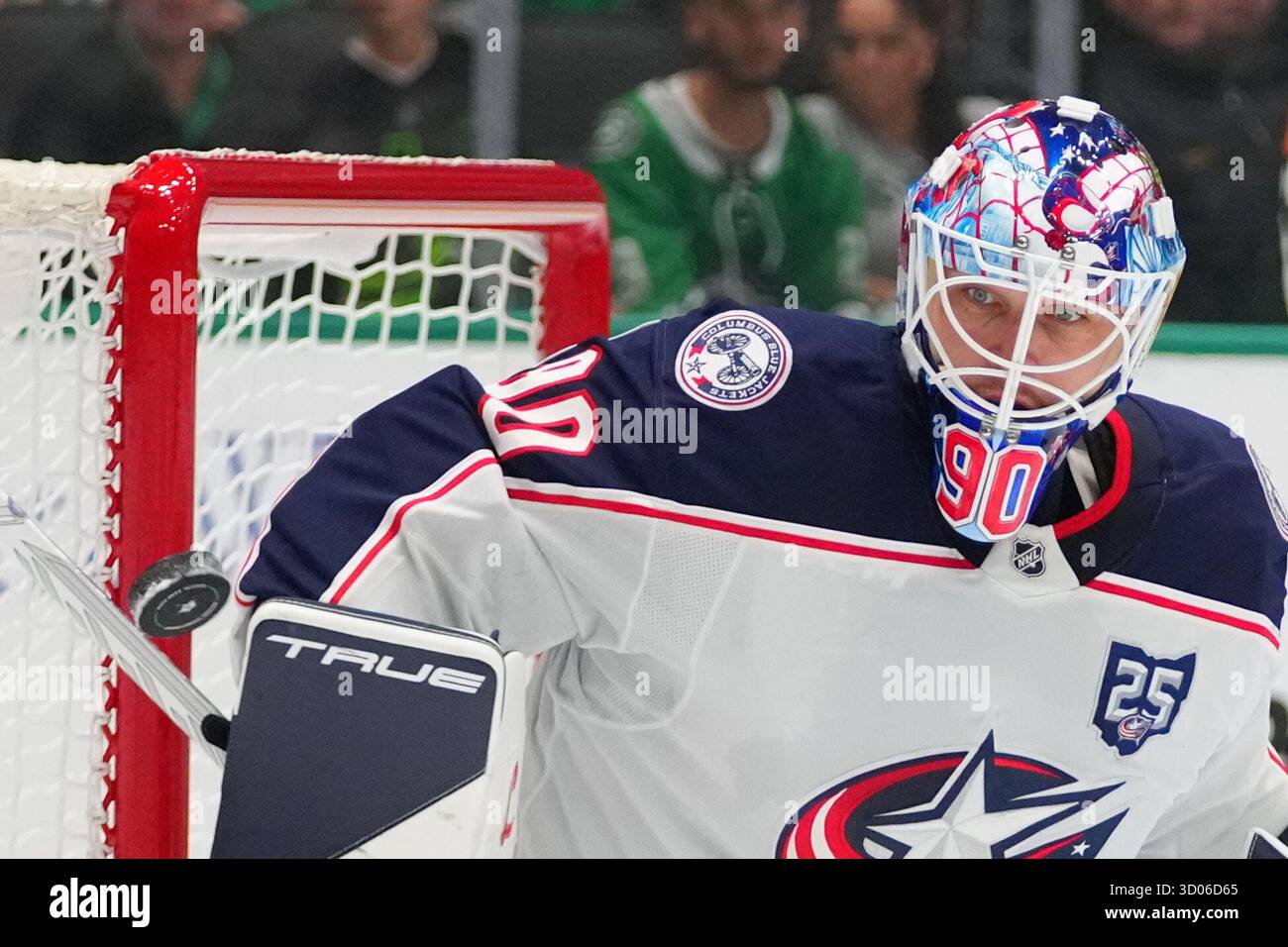 Columbus Blue Jackets goaltender Elvis Merzlikins deflects a shot by ...