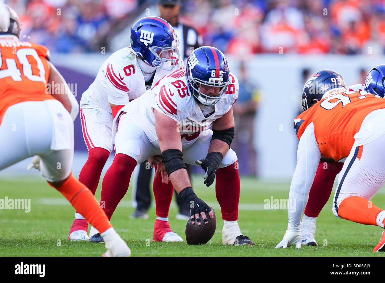 New York Giants guard Austin Schlottmann (65) snaps the ball to ...