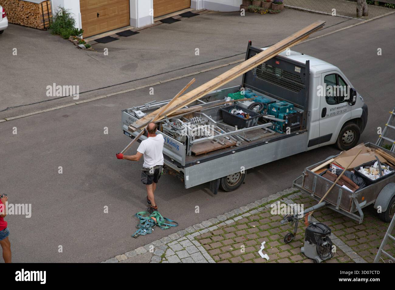 Repair team loading tools and wooden planks into a truck during ...