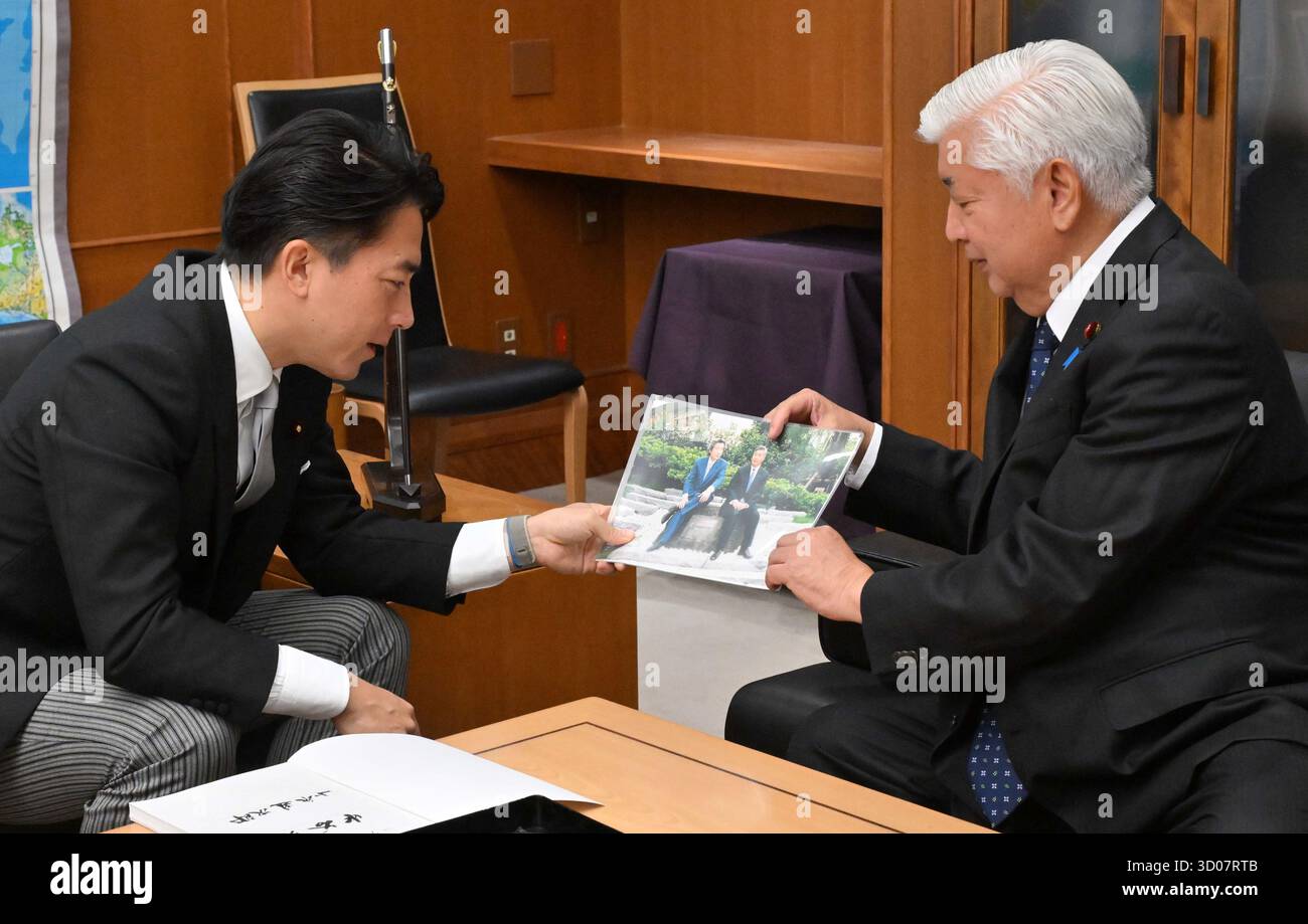Japanese Defense Minister Shinjiro Koizumi (L) assumes his role from ...