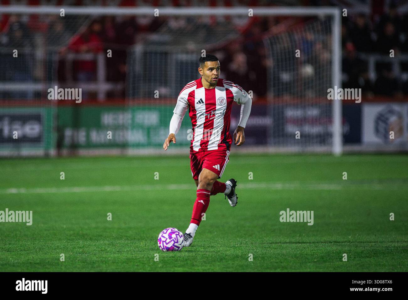 Brackley, UK. 21st Oct, 2025. Tyler Lyttle (2 Brackley Town) running ...