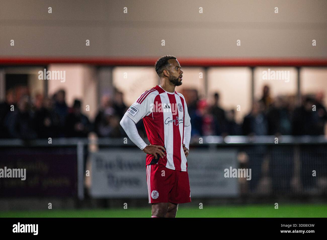 Brackley, UK. 21st Oct, 2025. Danny Waldron (14 Brackley Town) looks on ...