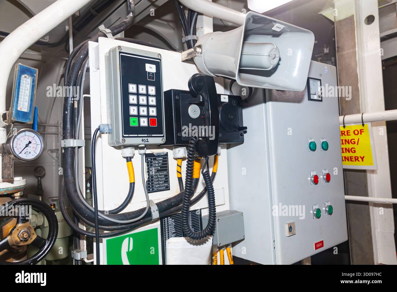 Part of the ship's engine room with a communications and alarm panel ...