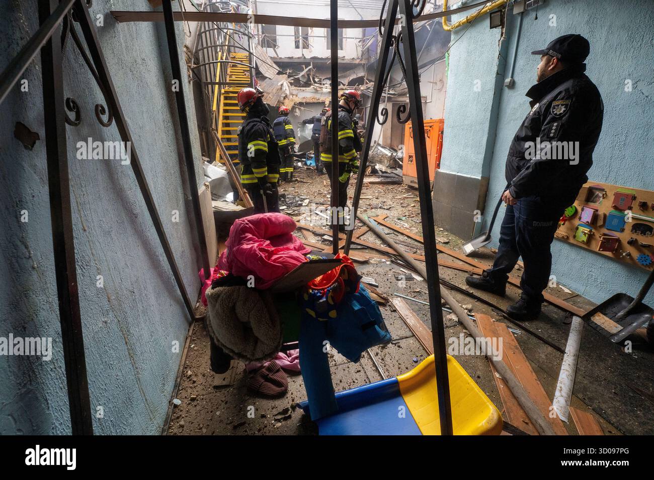 Police and firefighters inspect damage after Russian drones hit a city ...