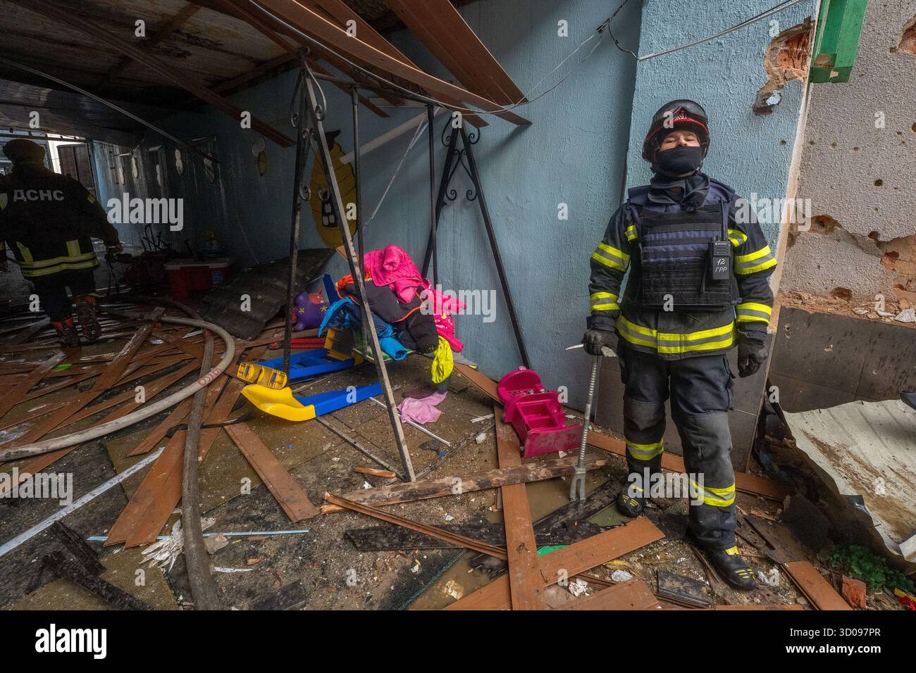 A firefighter inspects damage after Russian drones hit a city ...