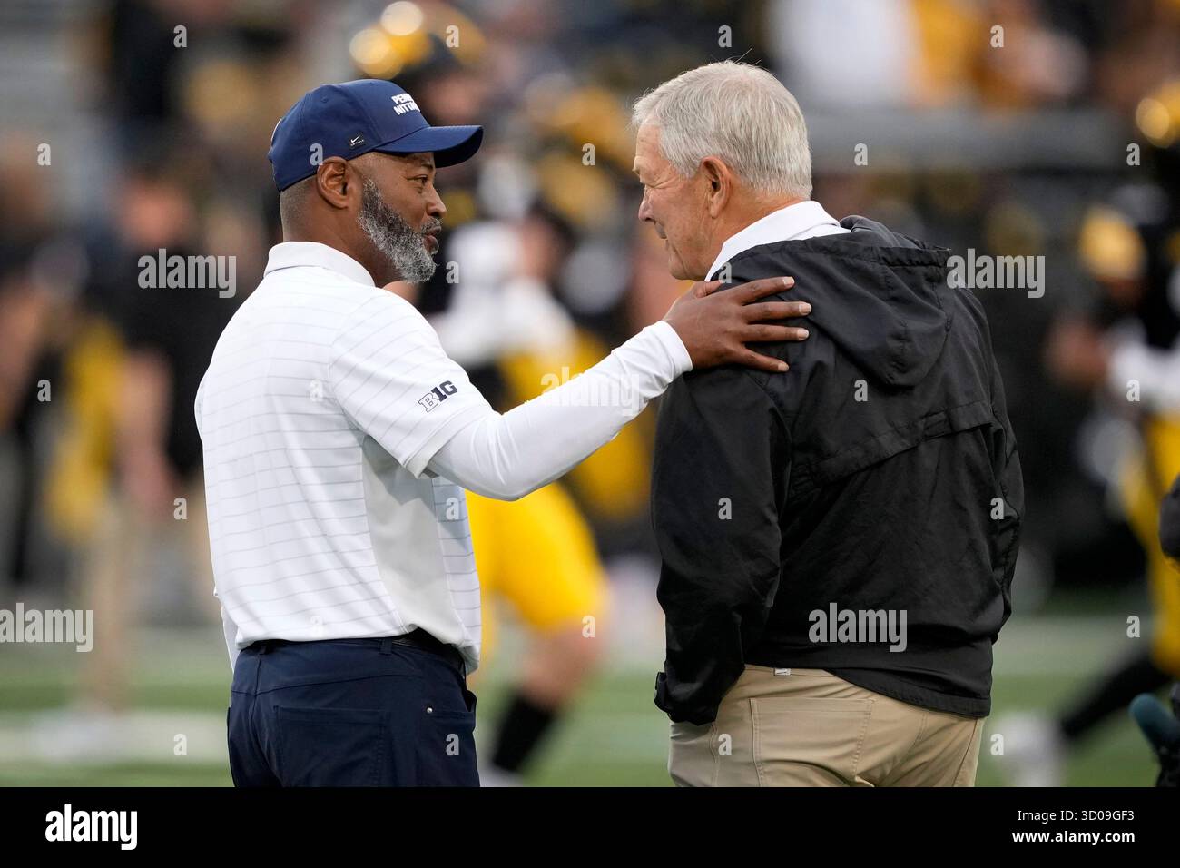 Penn State interim head coach Terry Smith, left, talks with Iowa head ...