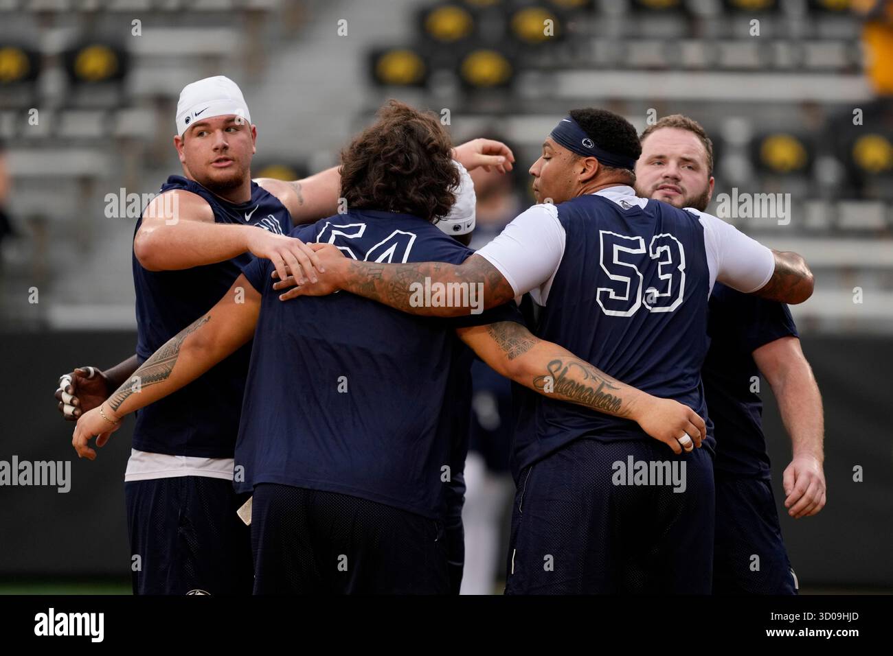 Penn State players huddle on the field before an NCAA college football ...