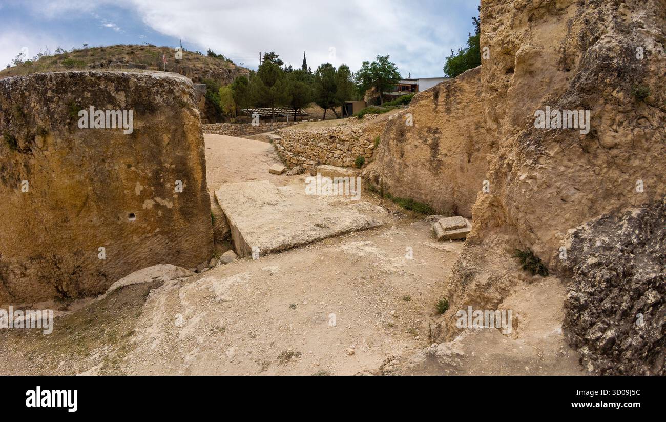 Ancient stone quarry with large rock formations and a pathway. Baalbek ...