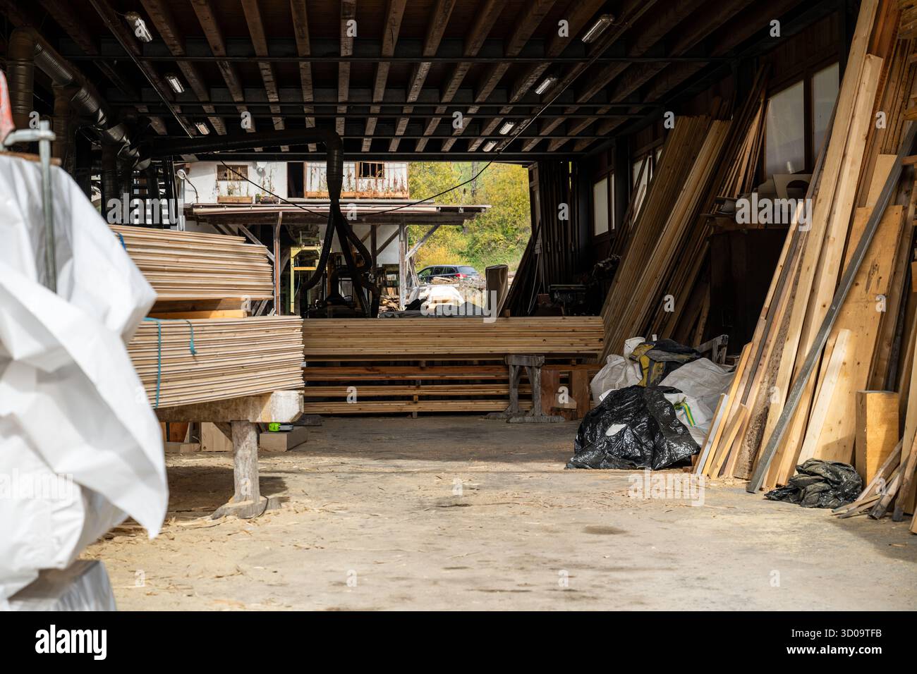 Interior of woodworking workshop with stacked timber boards and ...
