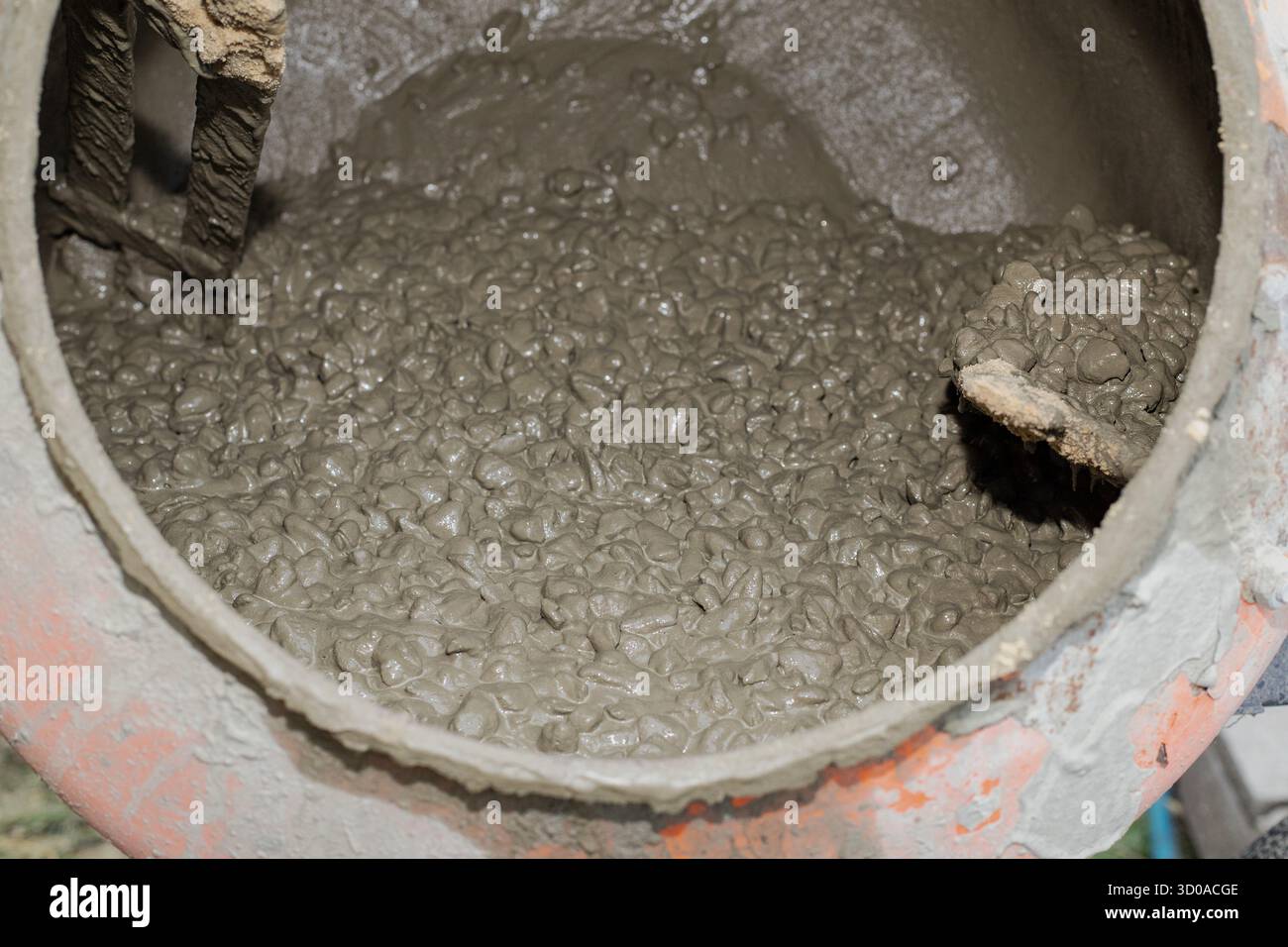 Wet concrete mix rotating inside cement mixer at construction site ...