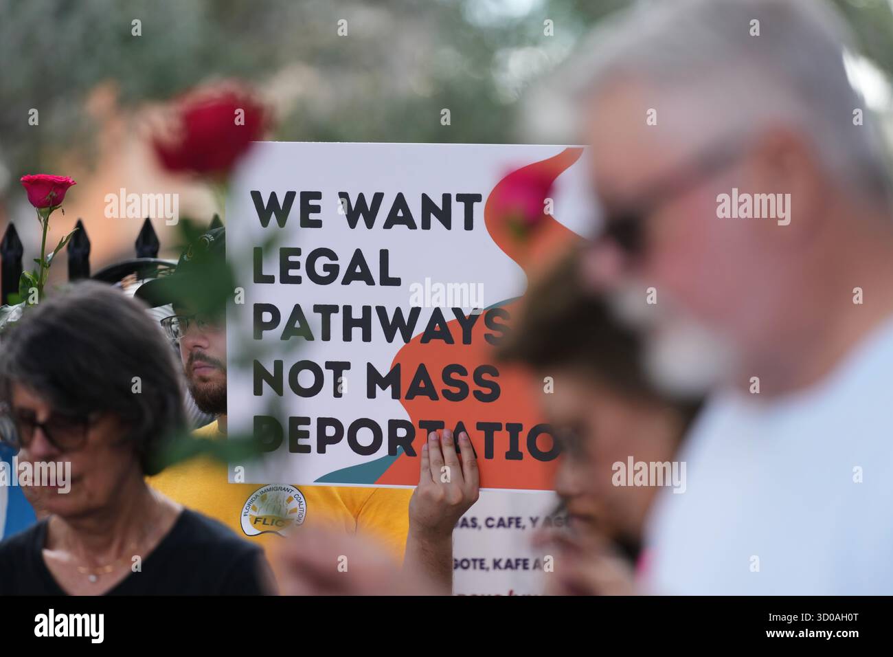 People hold red roses as they attend a prayer service in support of ...