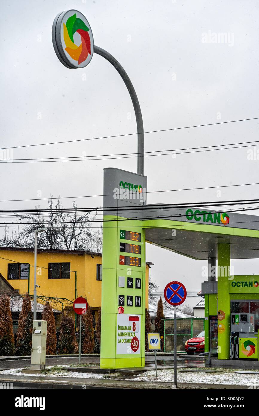 Exterior of an OCTANO gas station. Gasoline pumps and cars refueling in ...