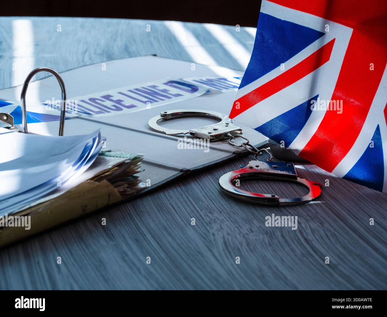 Police files with handcuffs in British police station Stock Photo - Alamy
