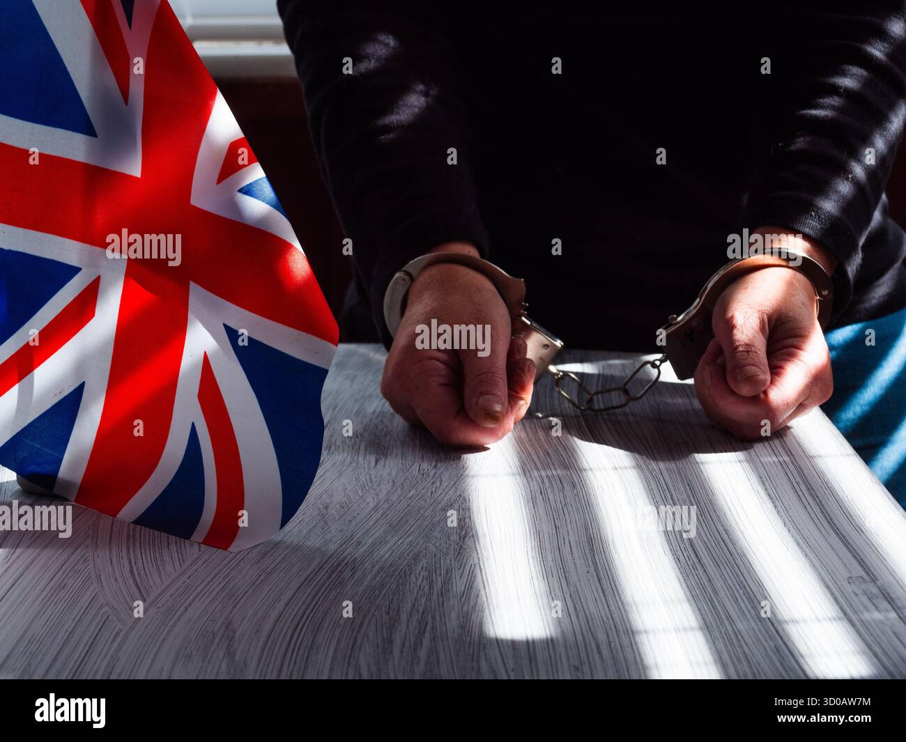 Criminal in handcuffs in British police room Stock Photo - Alamy