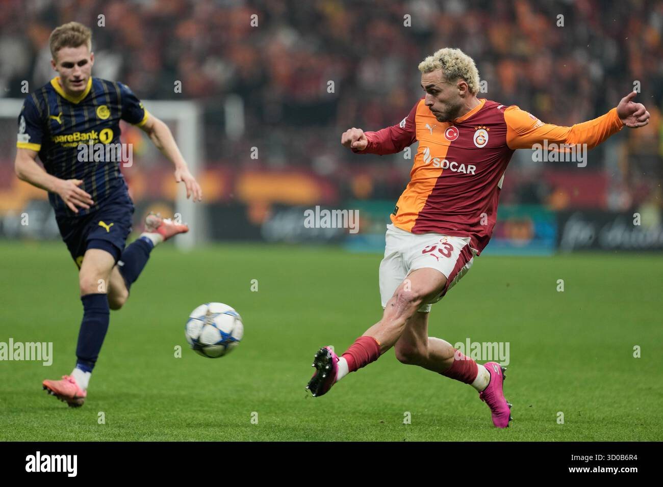 Galatasaray's Baris Yilmaz, right, kicks the ball during the Champions ...