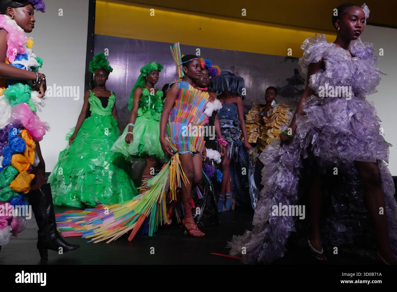 Models wearing an outfit made from recycled plastic waste walk the ...