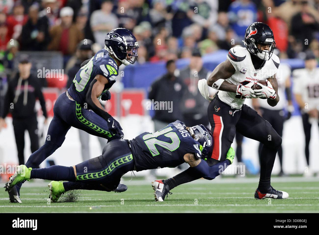 Houston Texans wide receiver Nico Collins (12) carries with Seattle ...