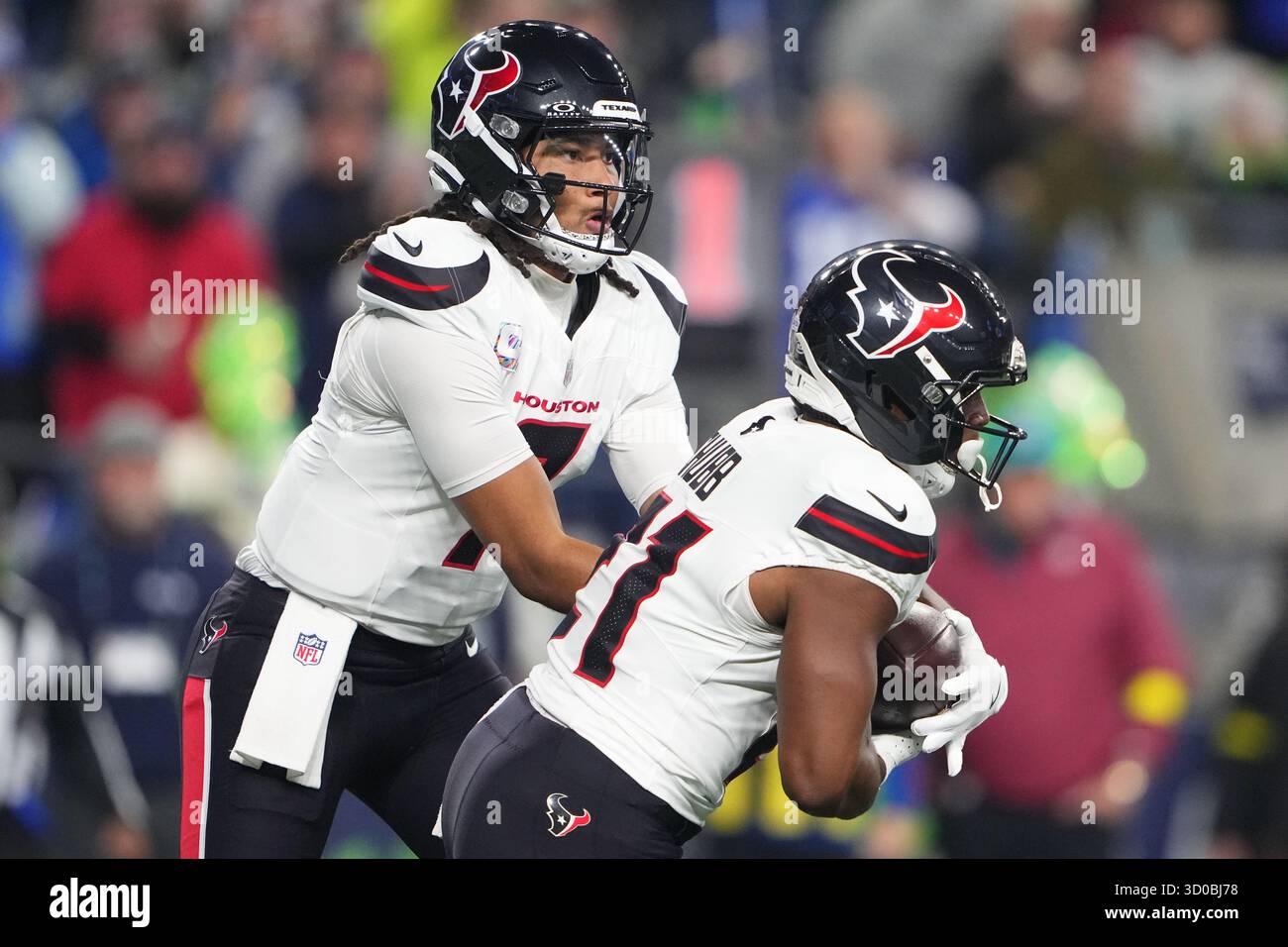 Houston Texans quarterback C.J. Stroud hands off the ball to running ...