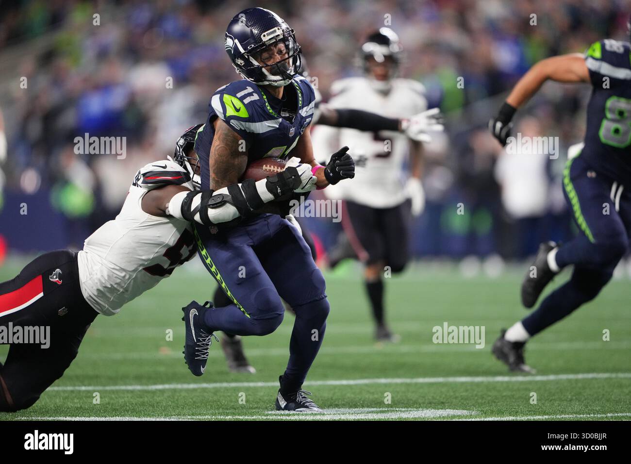 Seattle Seahawks wide receiver Jaxon Smith-Njigba runs the ball while being tackled by Houston ...