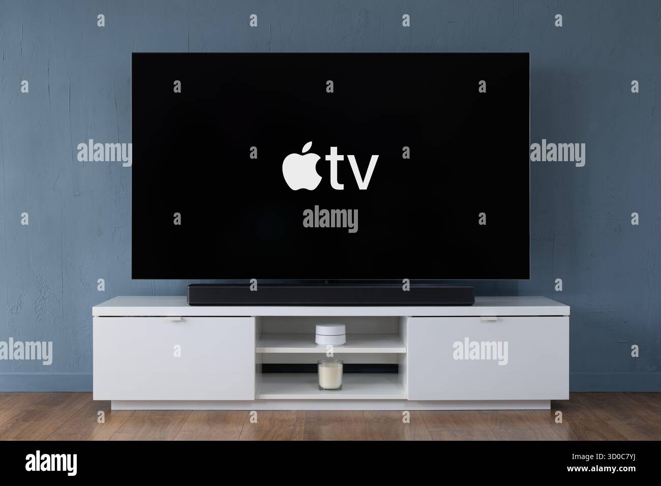 The Apple TV streaming service logo is seen on a modern OLED widescreen ...