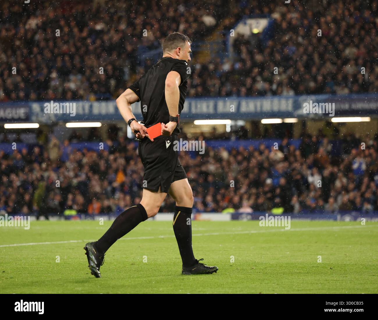Referee Felix Zwayer puts the red card back in his pocket after sending ...