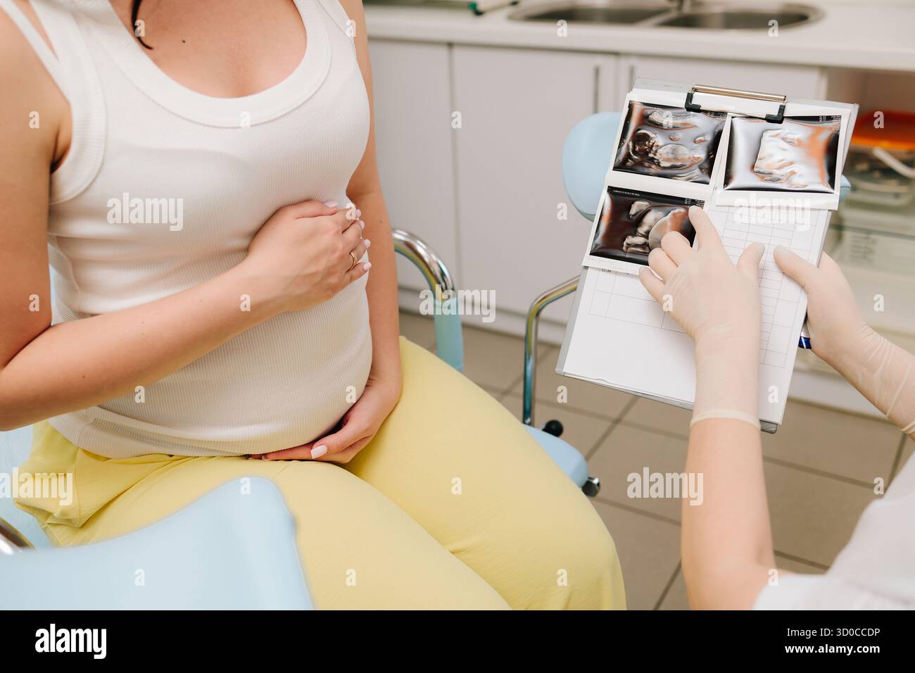 Gynecologist doctor consults patient expecting a baby about pregnancy ...