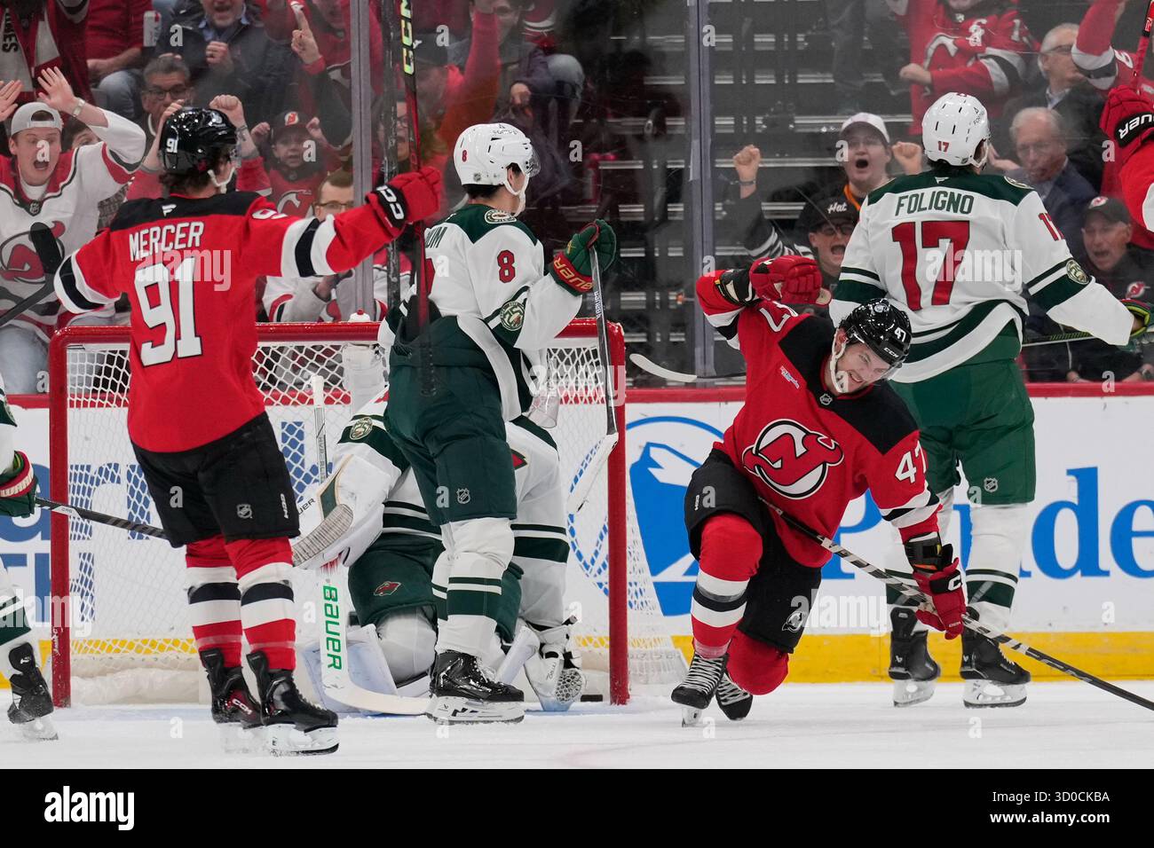 New Jersey Devils' Paul Cotter, second from right, reacts after scoring ...