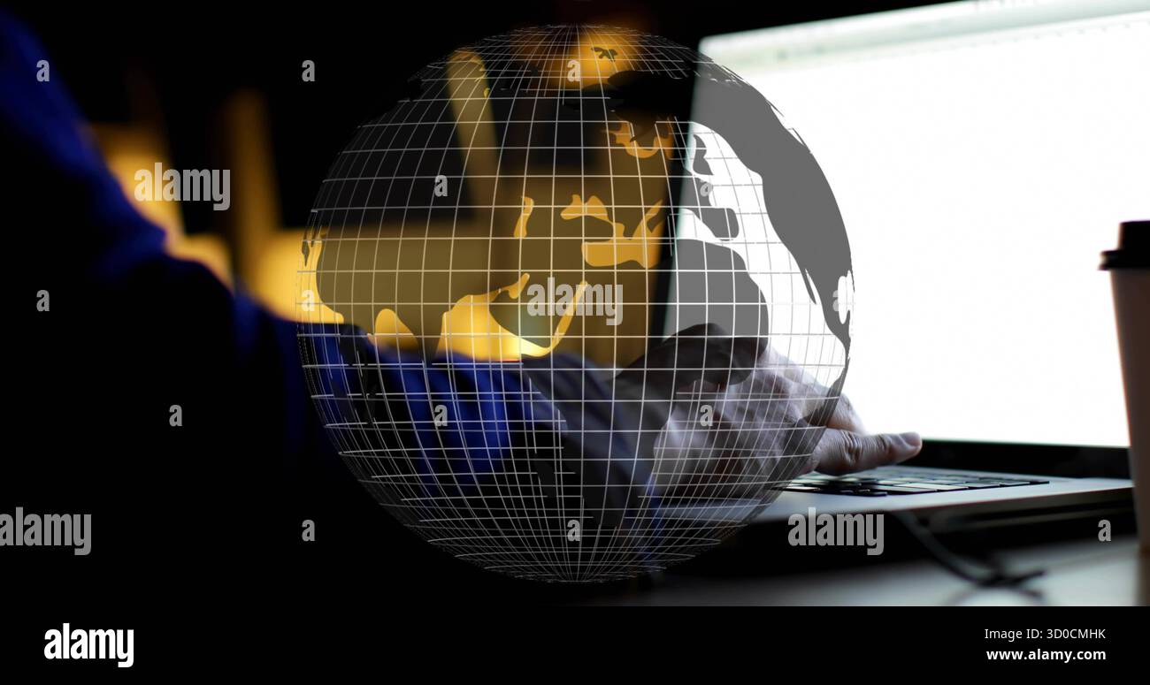 Typing hands in blue shirt on laptop keyboard at desk, with globe ...