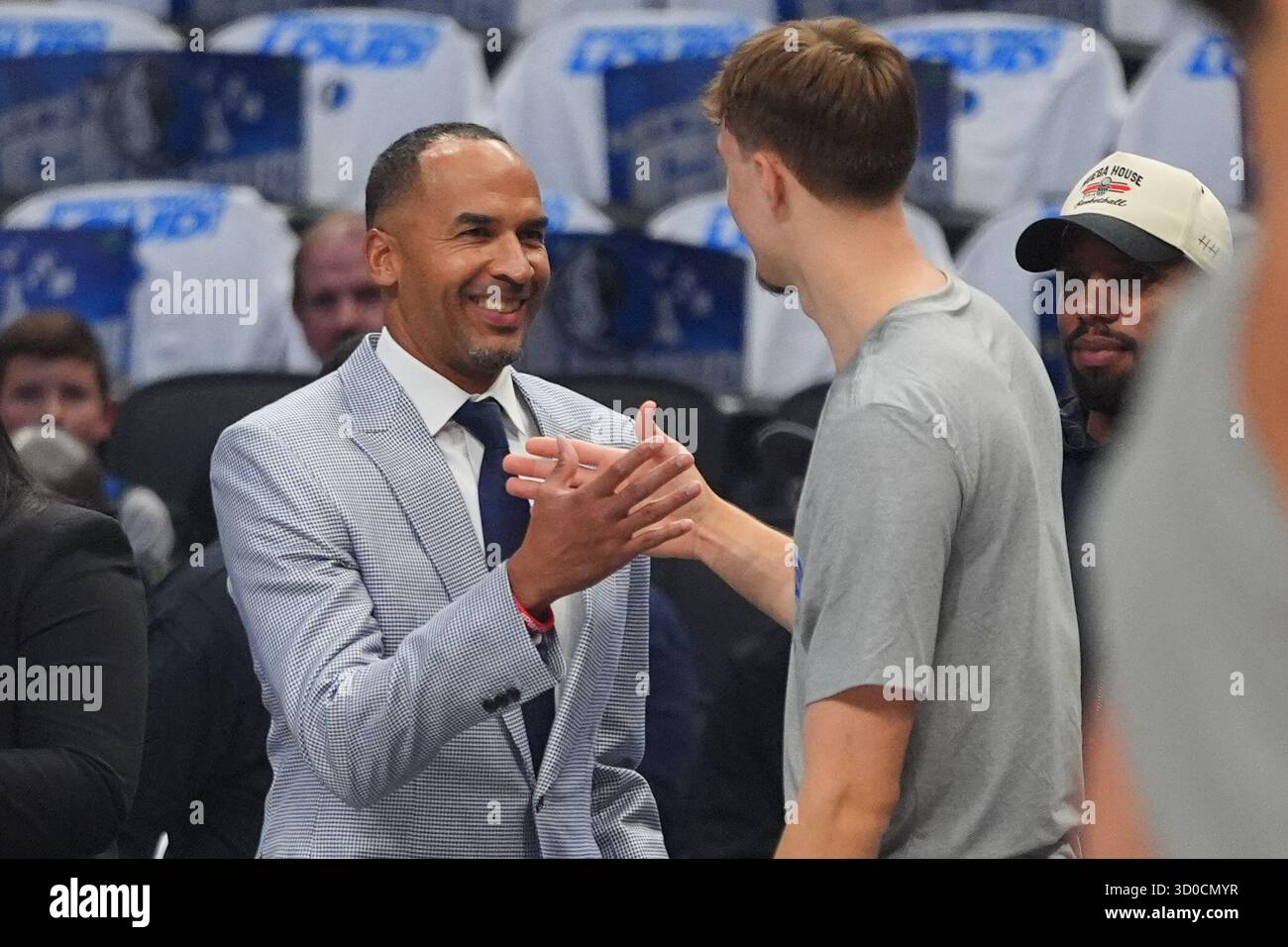 Dallas Mavericks general manager Nico Harrison, left, greets forward ...
