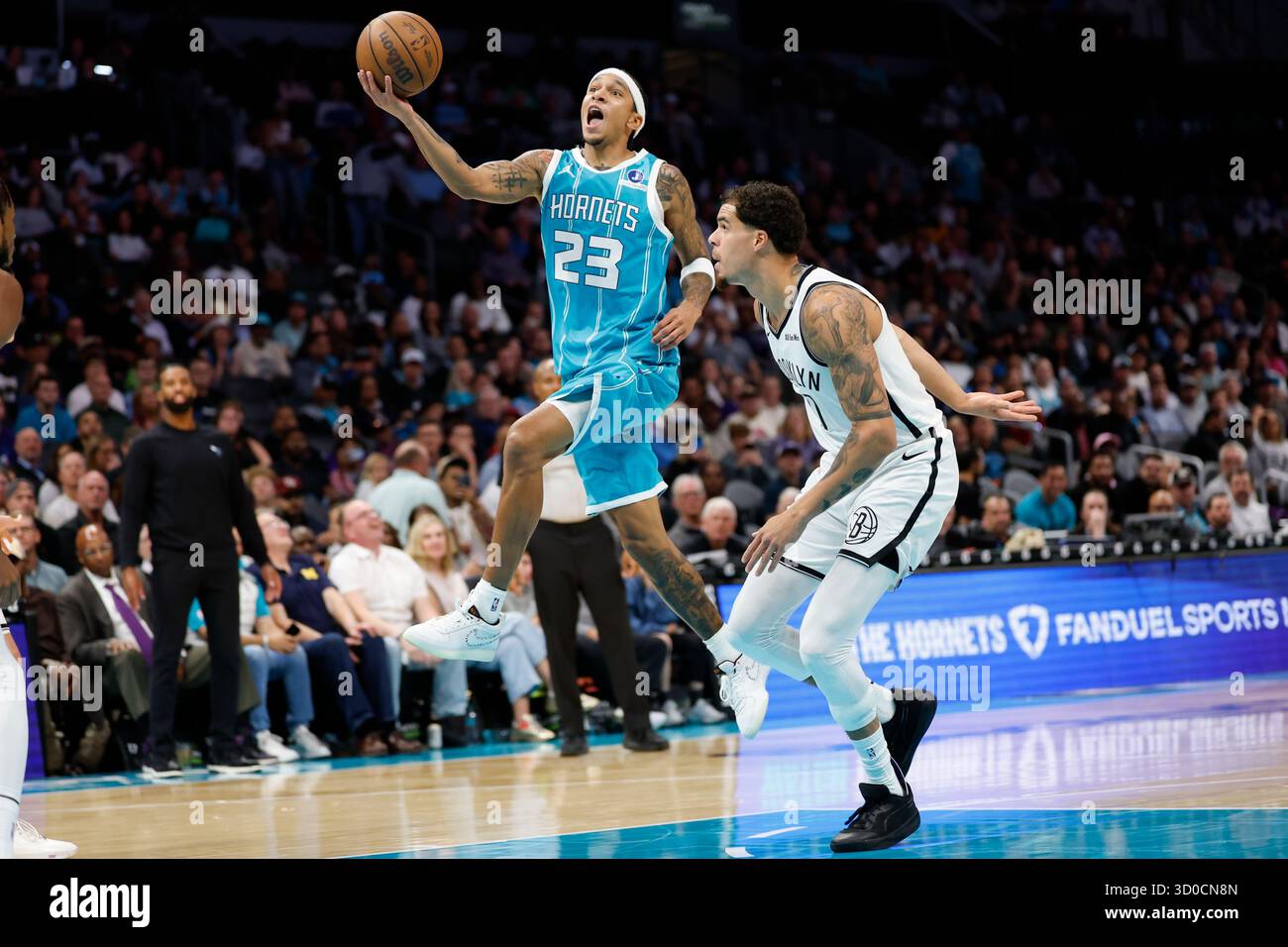 Charlotte Hornets guard Tre Mann (23) drives to the basket past ...