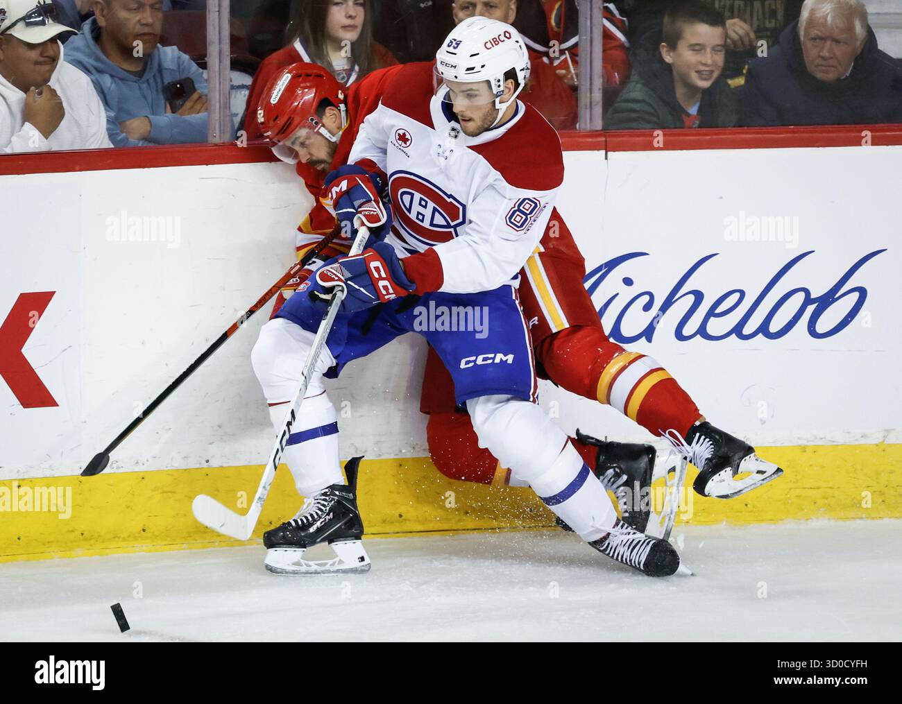 Montreal Canadiens' Joshua Roy, front, checks Calgary Flames' MacKenzie ...