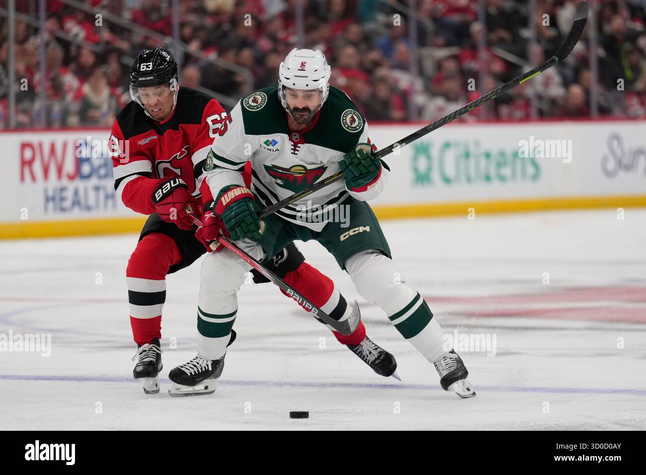 New Jersey Devils' Jesper Bratt, left, and Minnesota Wild's Jake ...