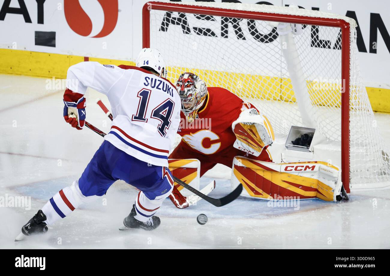 Montreal Canadiens' Nick Suzuki, left, tries to get the puck past ...