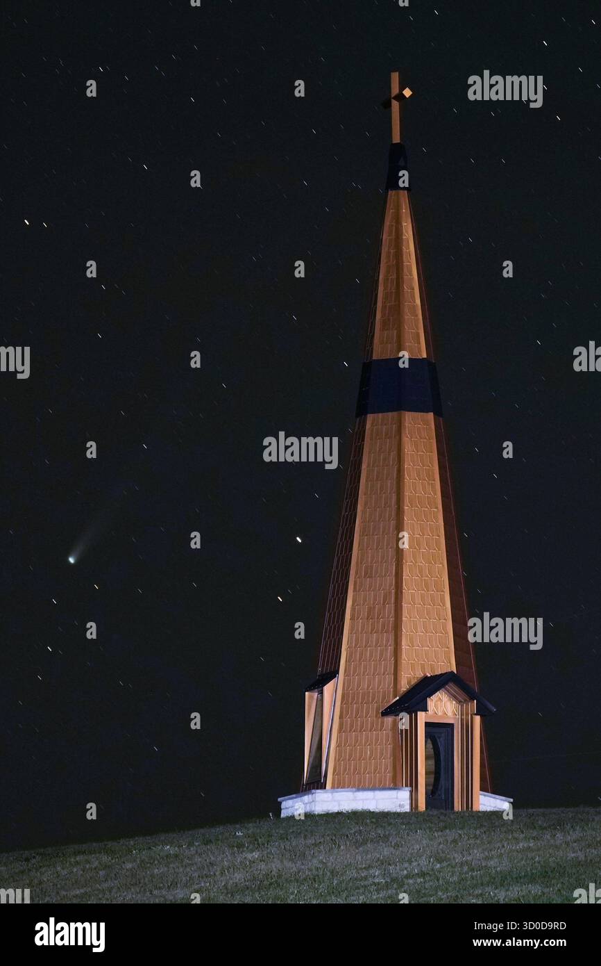 Comet Lemmon is seen in the sky beyond the Saint Joseph the Woodworker ...