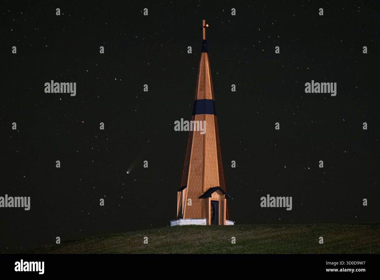 Comet Lemmon is seen in the sky beyond the Saint Joseph the Woodworker ...