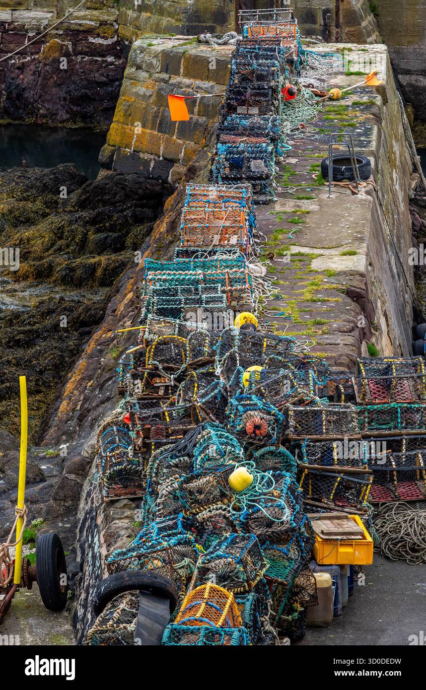 Stacked lobster pots and fishing gear on a harbour wall Stock Photo - Alamy