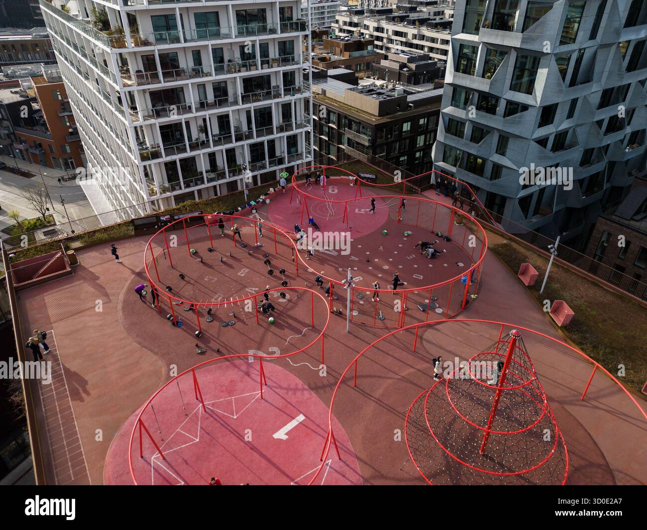 Aerial view of a vibrant red rooftop playground teeming with activity ...