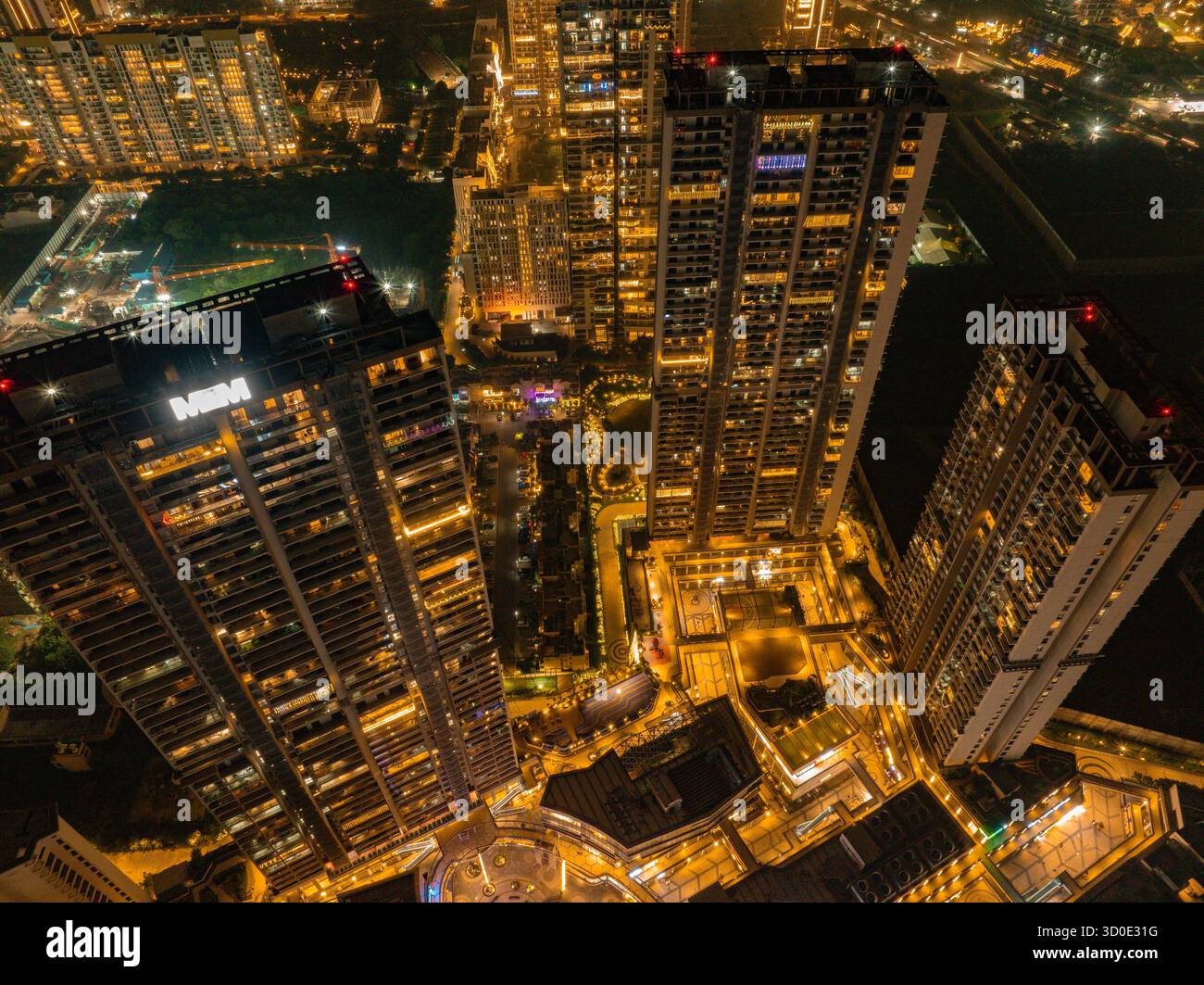 Aerial view of glittering towers piercing the night sky, their lights ...
