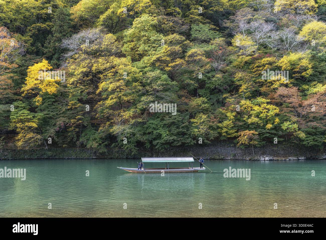 Katsura River boat ride taken during autumn foliage season. boatmen ...