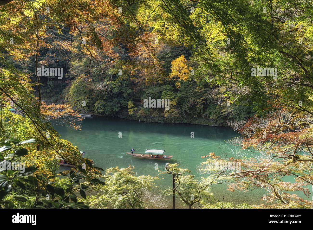Katsura River boat ride taken during autumn foliage season. boatmen ...