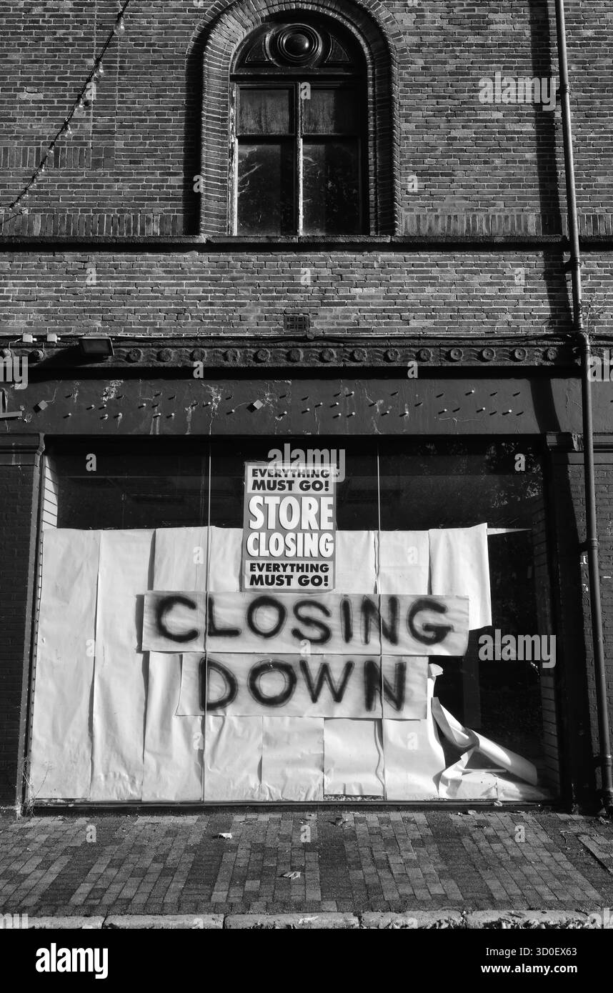 Black and white photo of a closed shop window with paper covering, bold ...