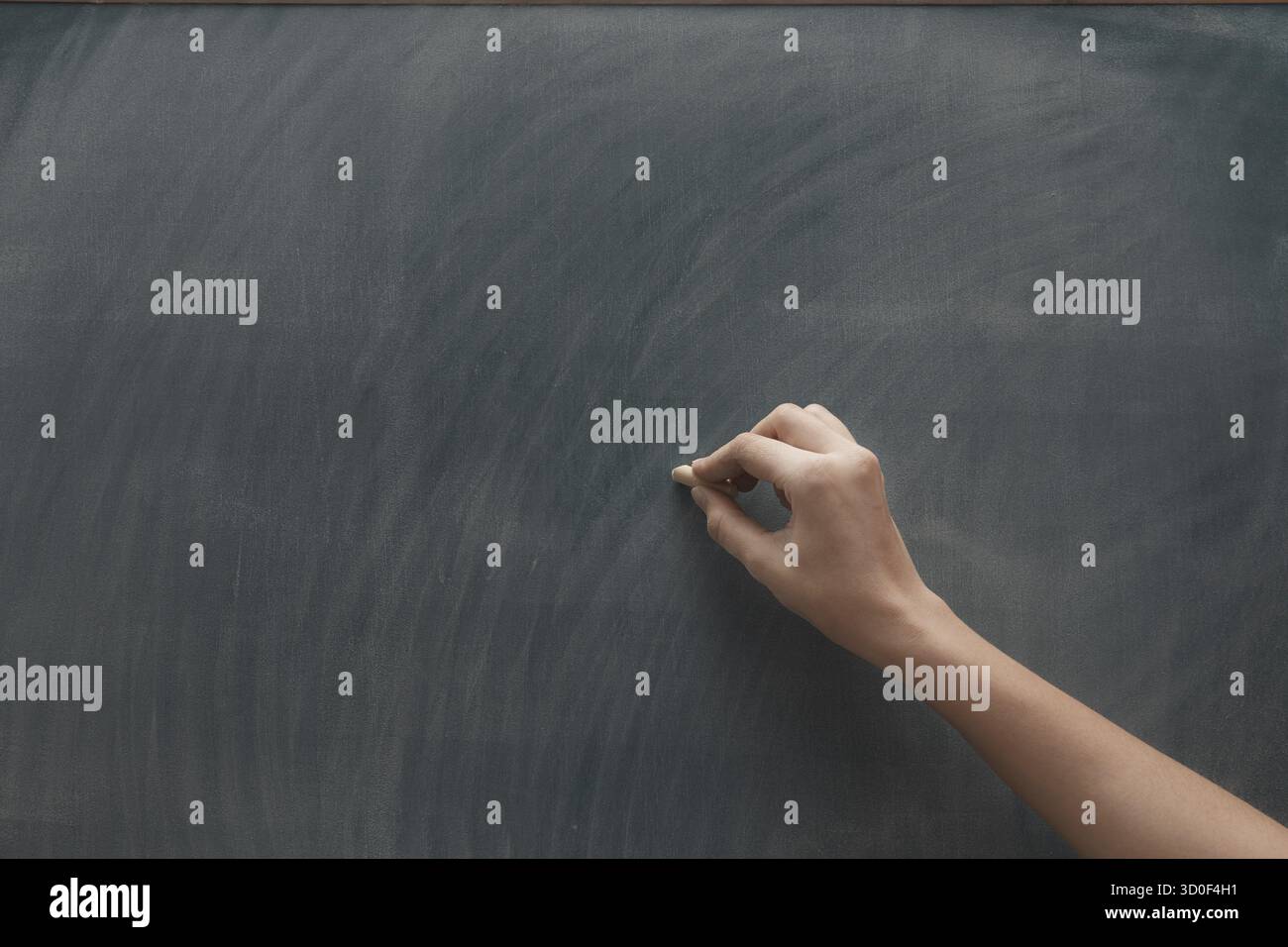 Human hand with chalk at the blackboard Stock Photo - Alamy