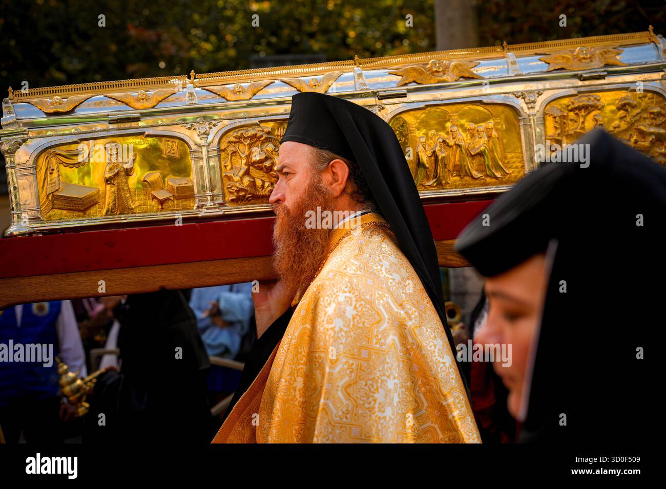 An Orthodox priest carries holy remains during the procession of Saint ...